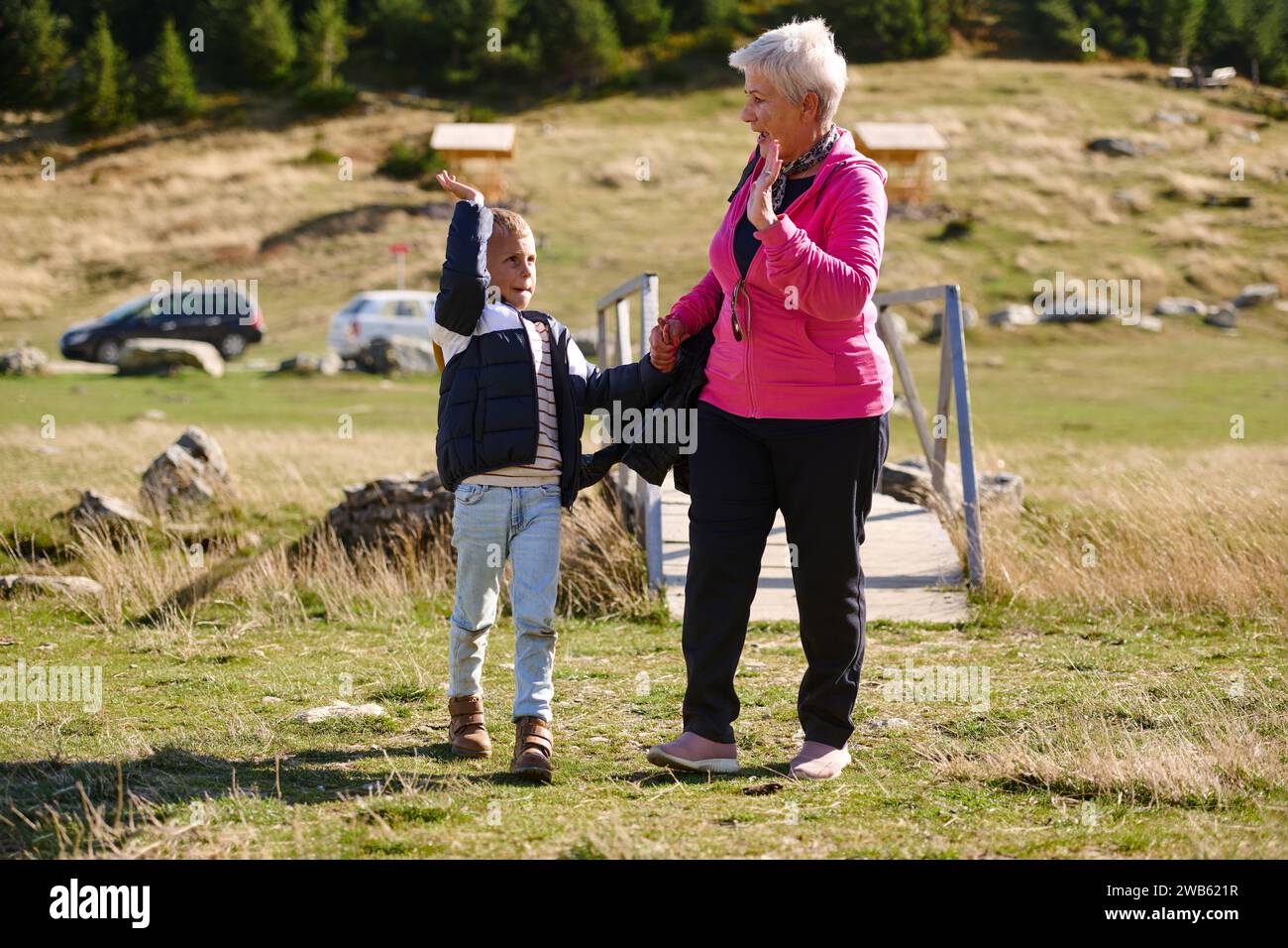 Elderly grandmother and her grandchild share a leisurely stroll through ...