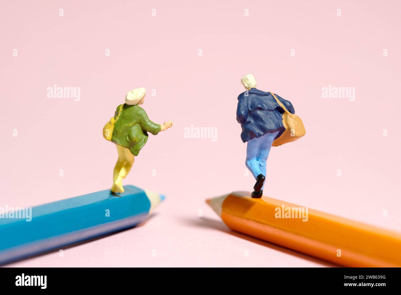 Miniature tiny people toy figure photography. Two college students ...