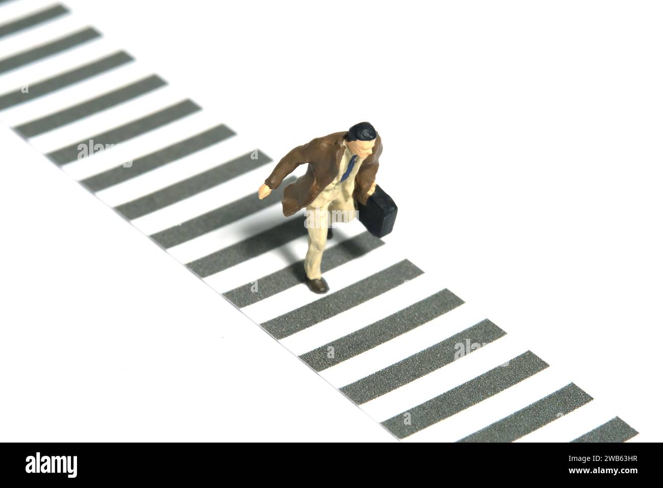 Miniature tiny people toy figure photography. A businessman wearing ...