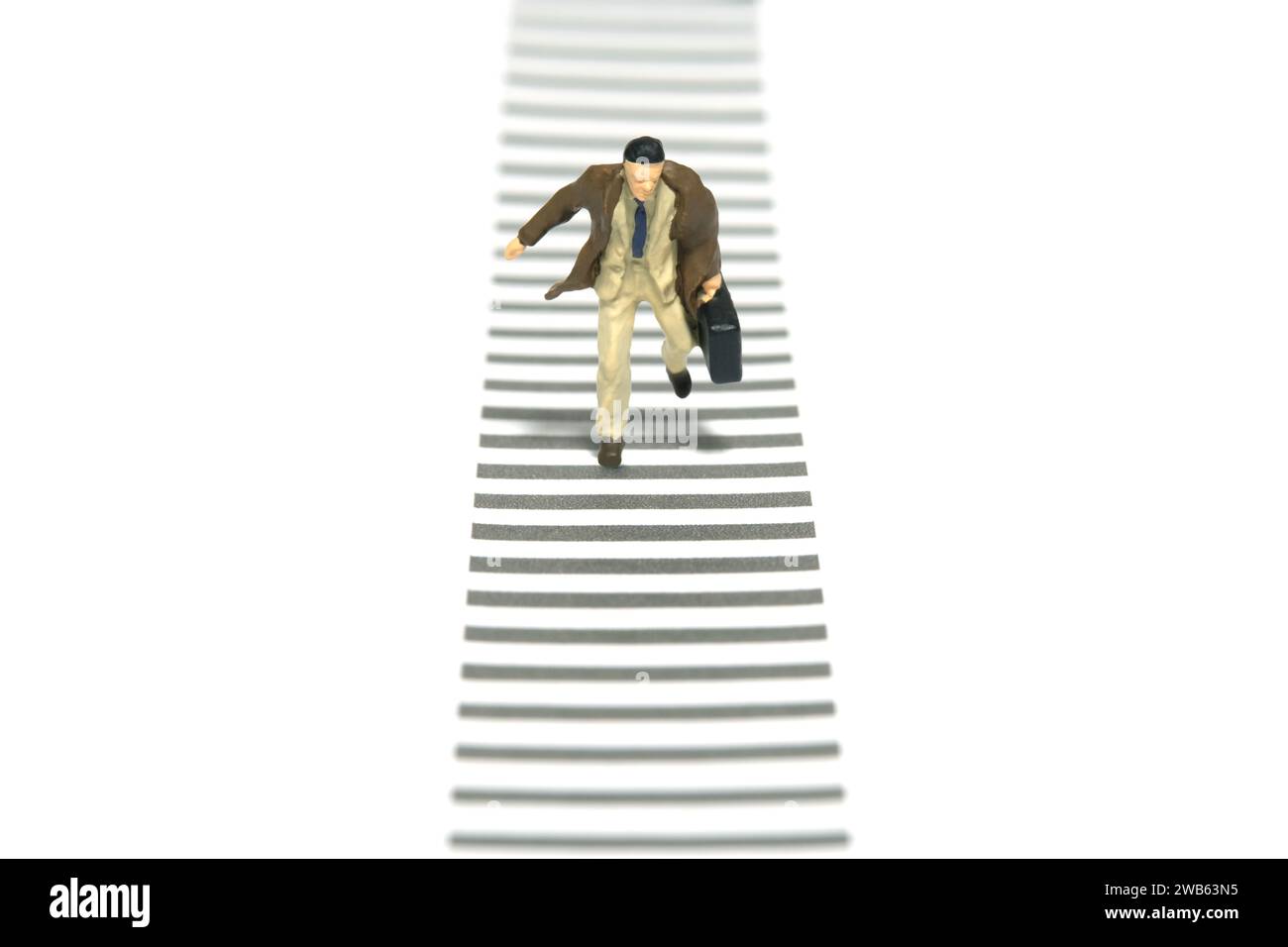 Miniature tiny people toy figure photography. A businessman wearing ...