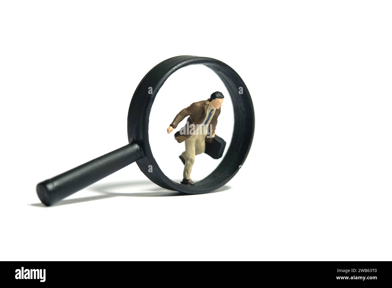 Miniature tiny people toy figure photography. A businessman running on ...