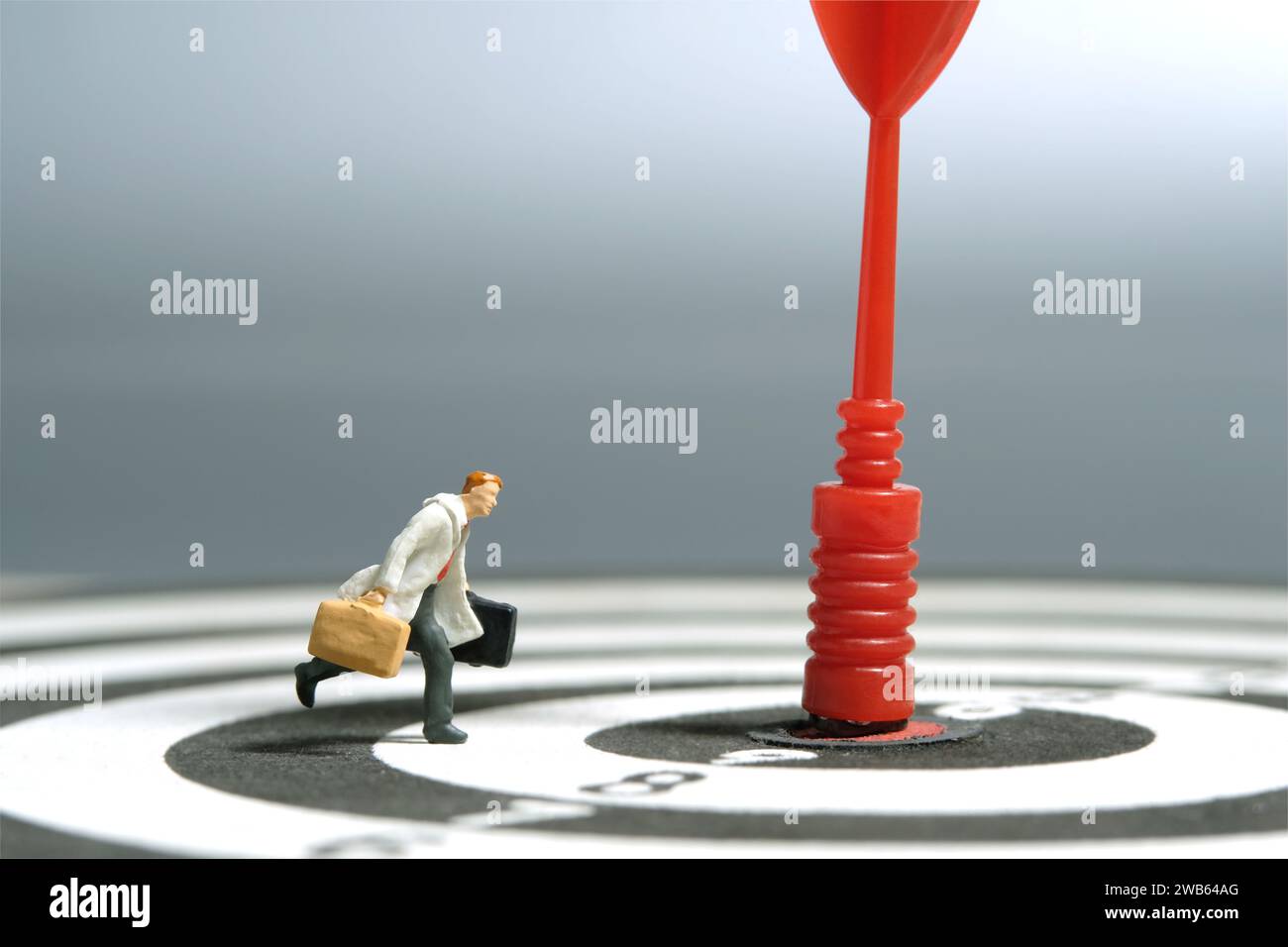 Miniature tiny people toy figure photography. A businessman running ...