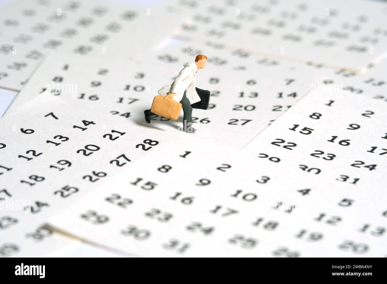 Miniature tiny people toy figure photography. A businessman running ...