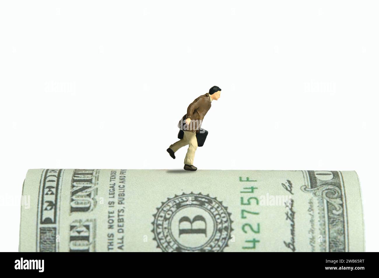 Miniature tiny people toy figure photography. A businessman wearing ...
