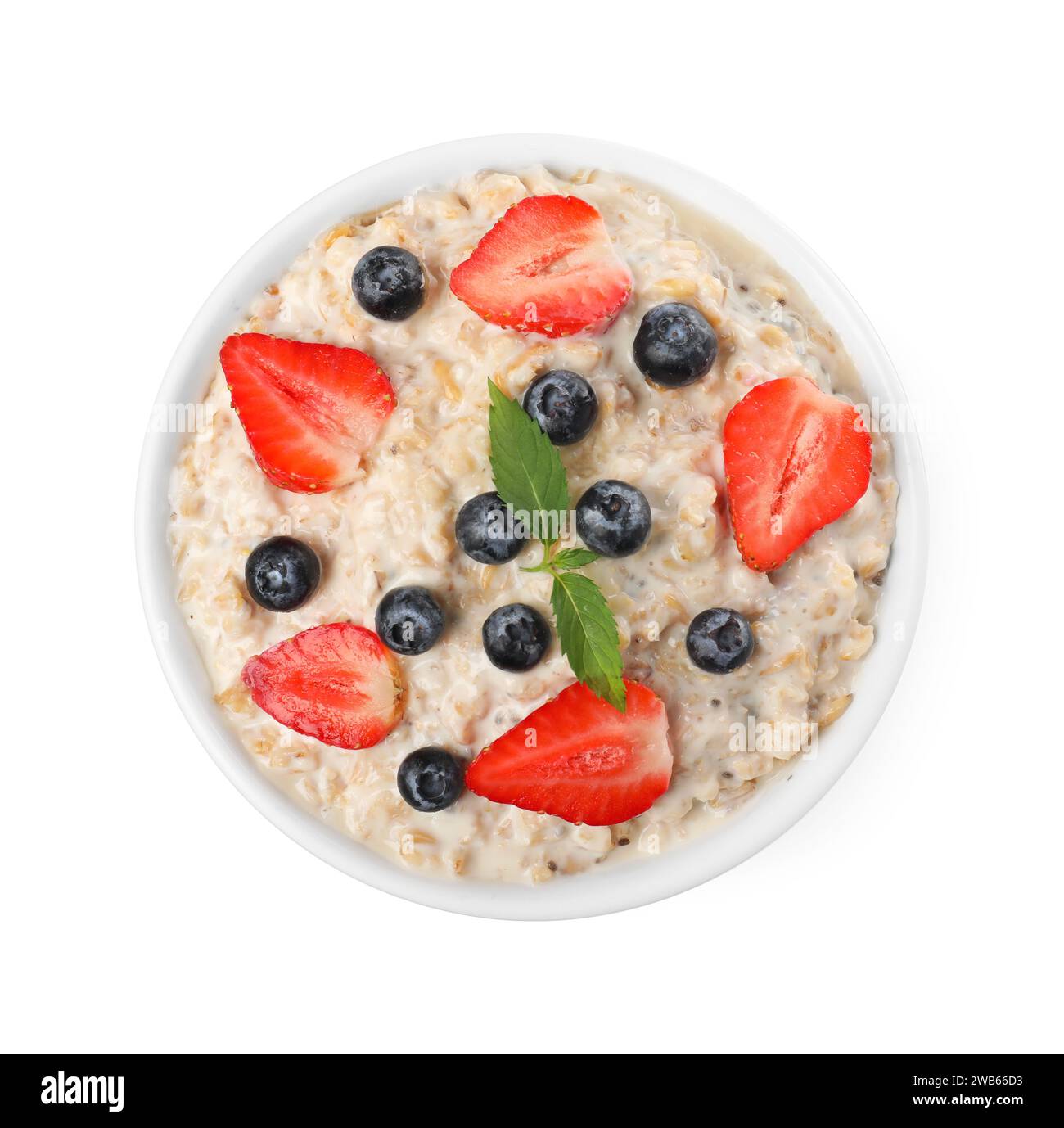 Tasty boiled oatmeal with berries in bowl isolated on white, top view ...