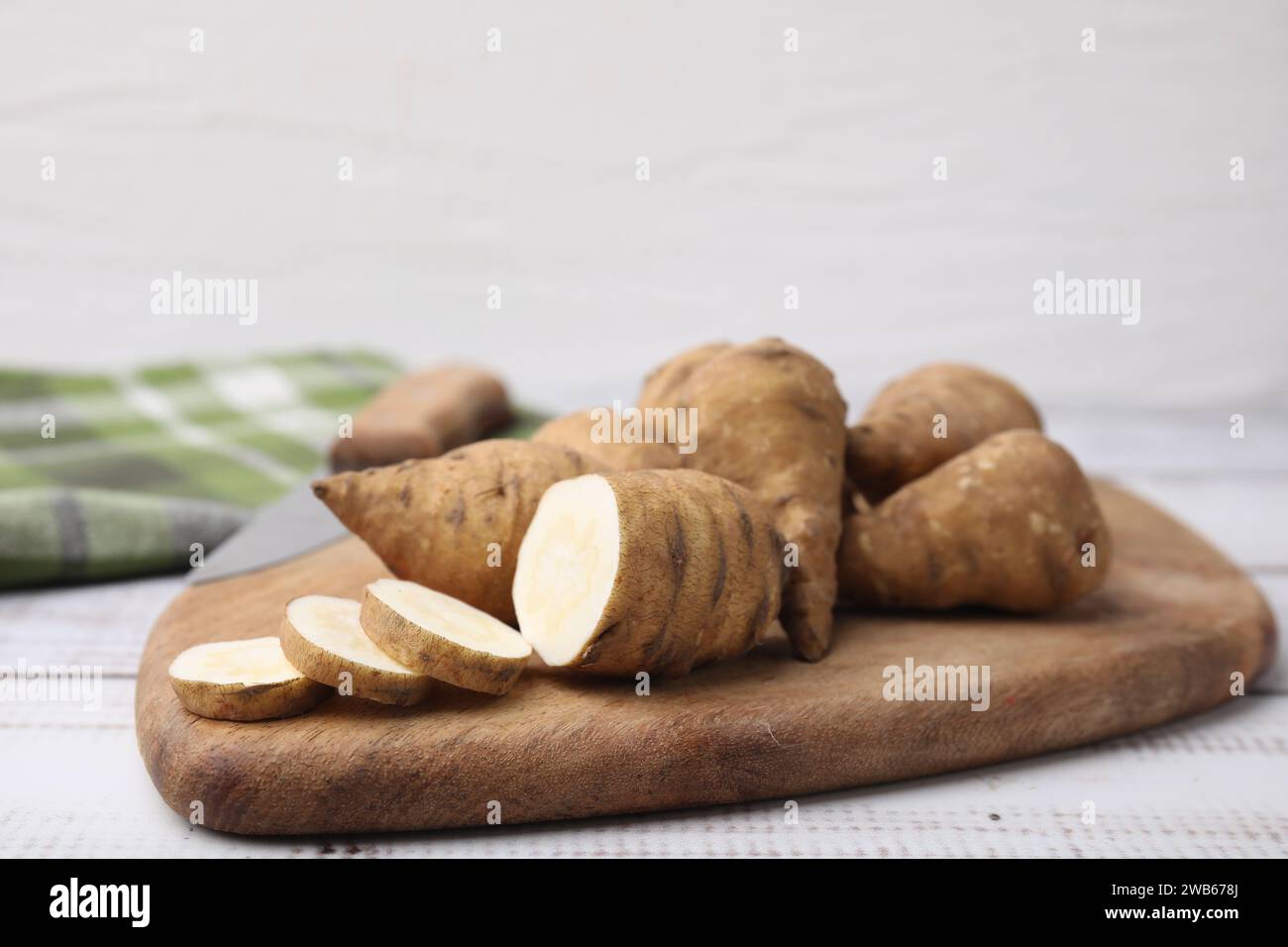 Whole and cut turnip rooted chervil tubers on wooden table Stock Photo ...