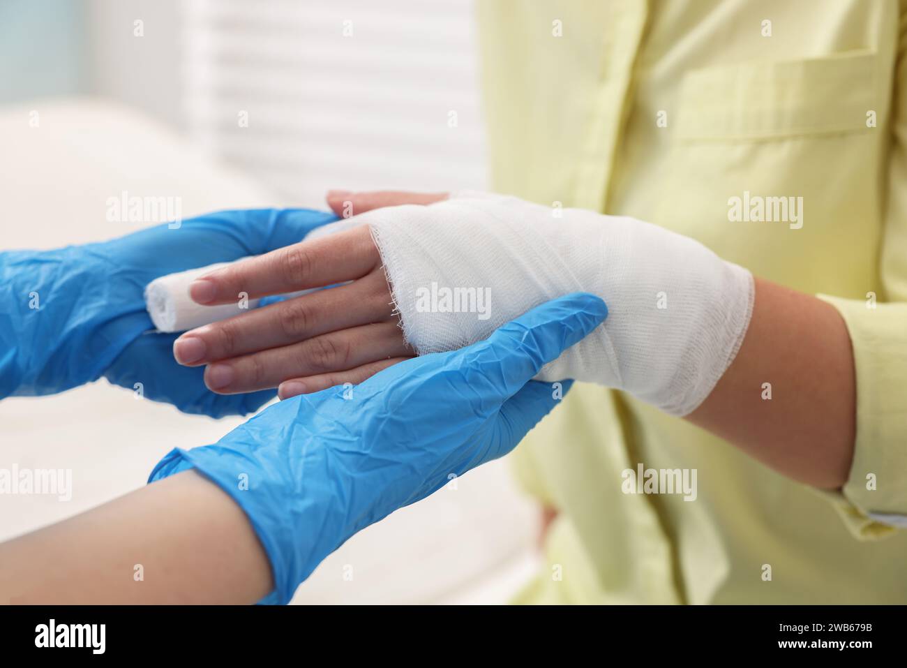 Doctor bandaging patient's burned hand indoors, closeup Stock Photo - Alamy