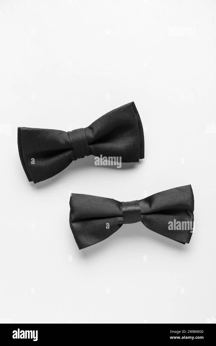 Black bow ties on white background Stock Photo - Alamy