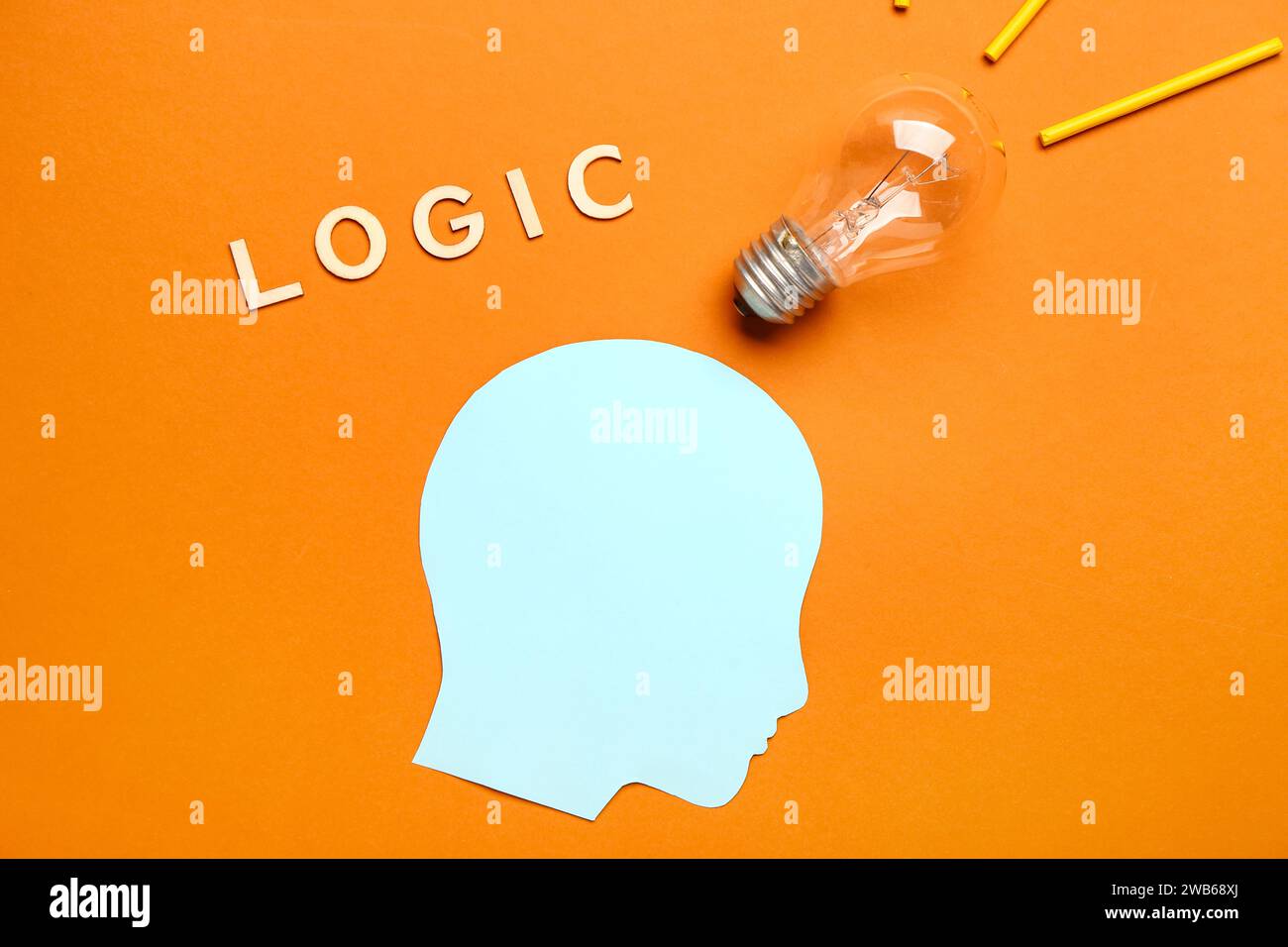 Paper human head with light bulb and word LOGIC on color background ...