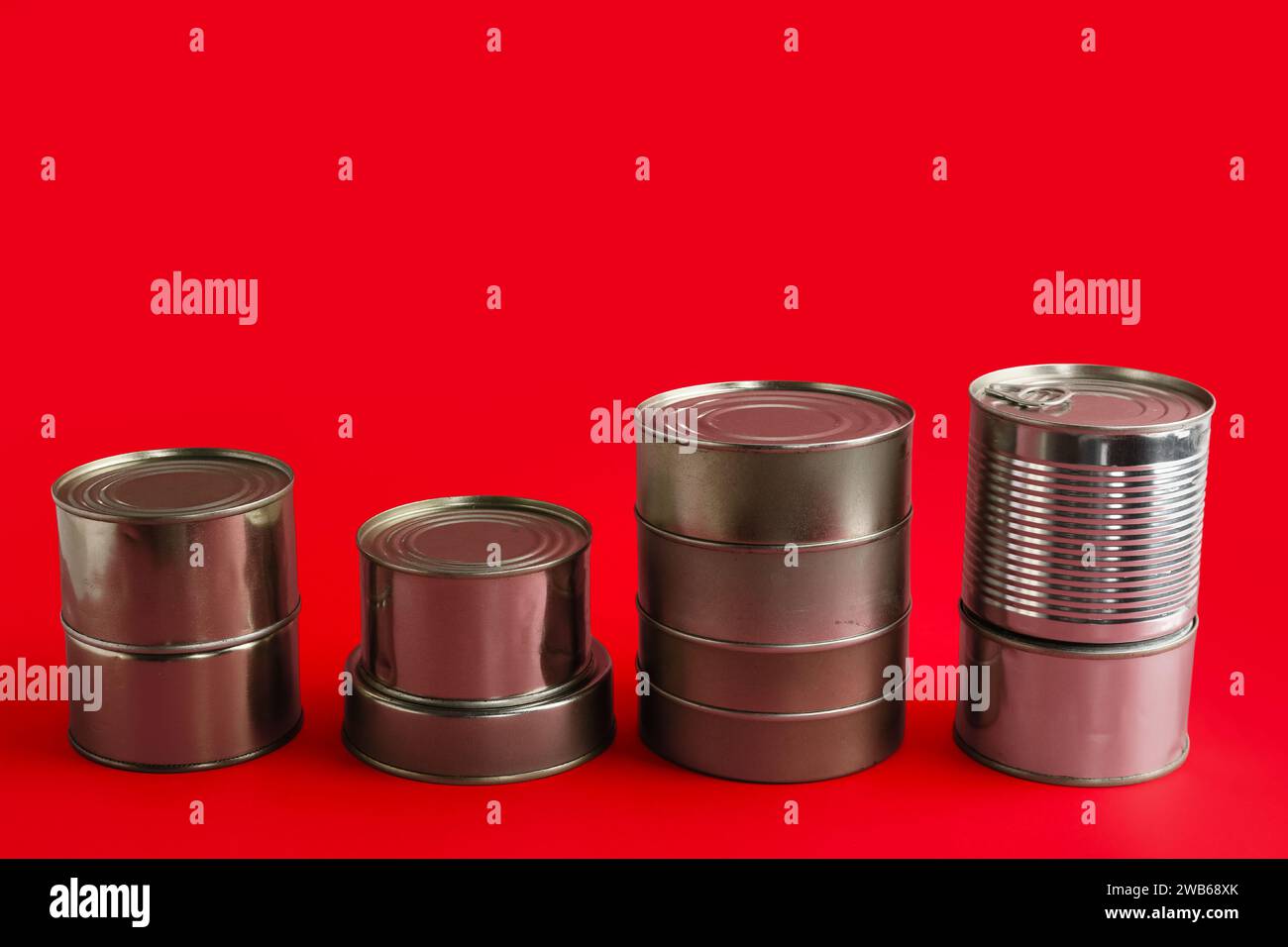 Stacks of tin cans with fish on red background Stock Photo - Alamy