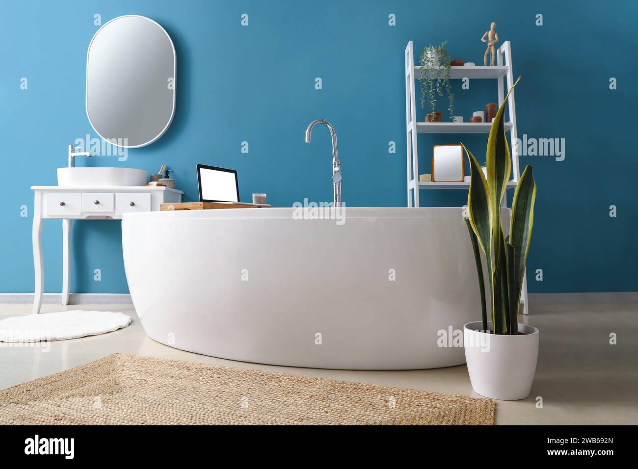 Interior of bathroom with bathtub, modern laptop and mirror Stock Photo ...
