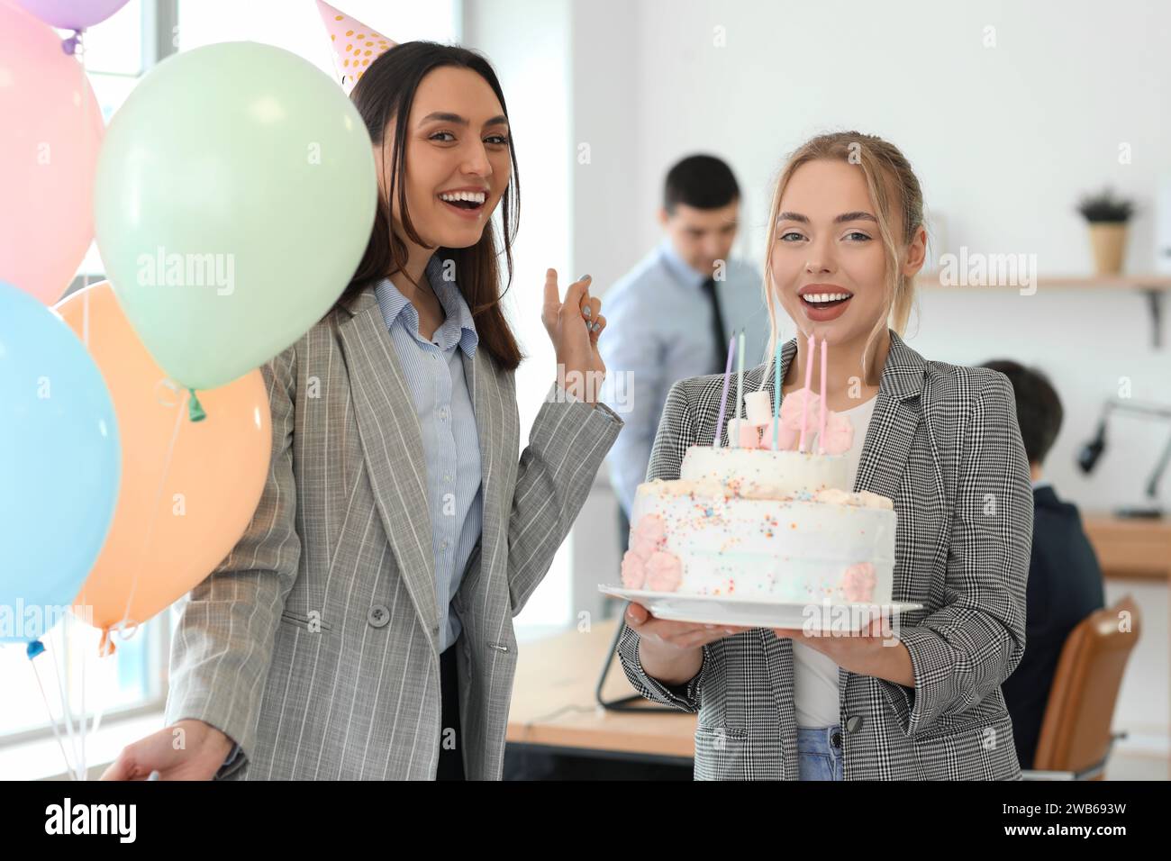Female colleagues with Birthday cake at party in office Stock Photo - Alamy