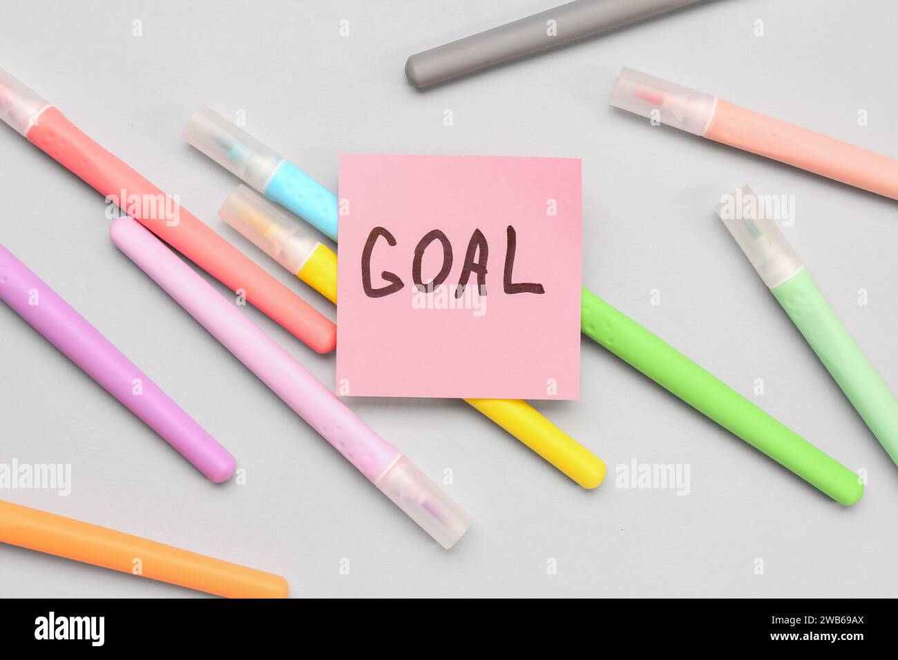 Sticky note with word GOAL and felt-tip pens on light background Stock ...