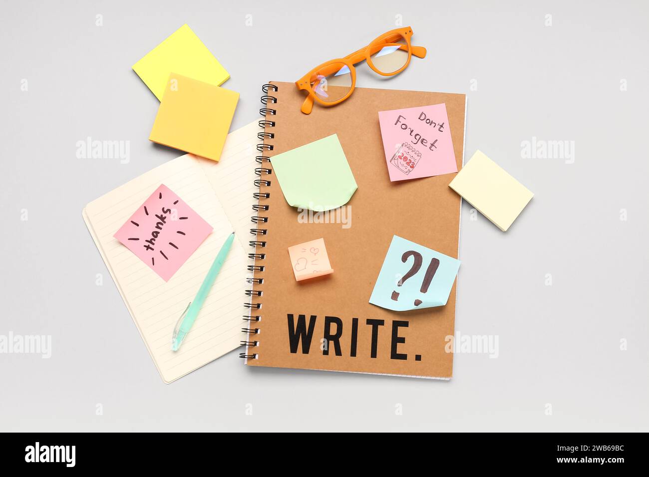 Sticky notes with notebooks and eyeglasses on light background Stock ...