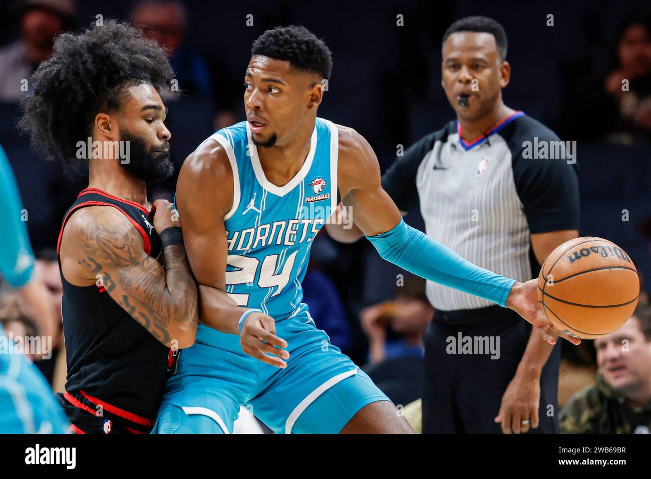 Charlotte Hornets forward Brandon Miller, front right, looks to pass ...