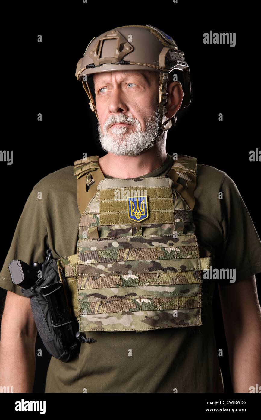 Ukrainian soldier with armor on dark background Stock Photo - Alamy