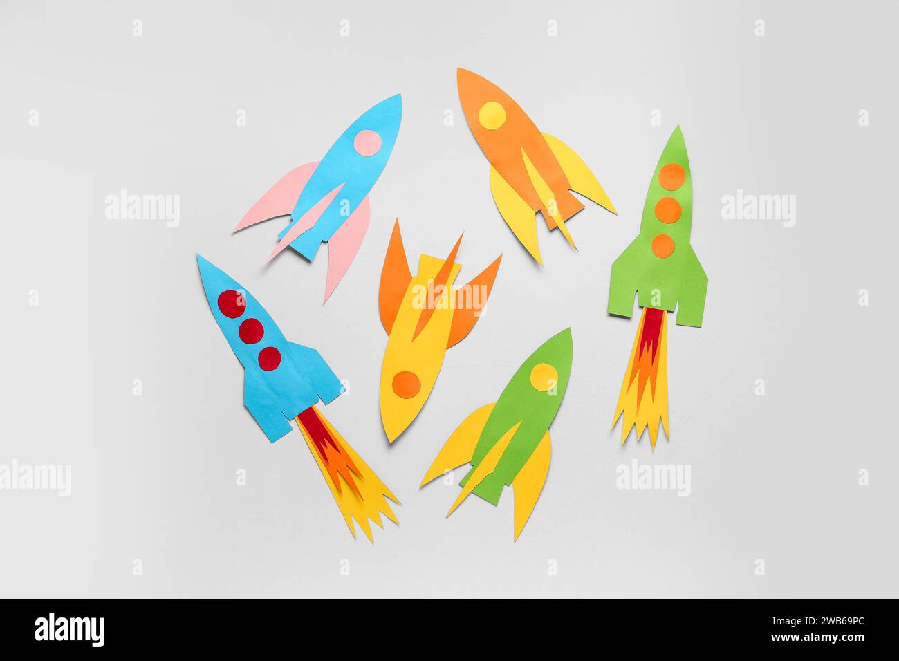 Color paper rockets on white background Stock Photo - Alamy