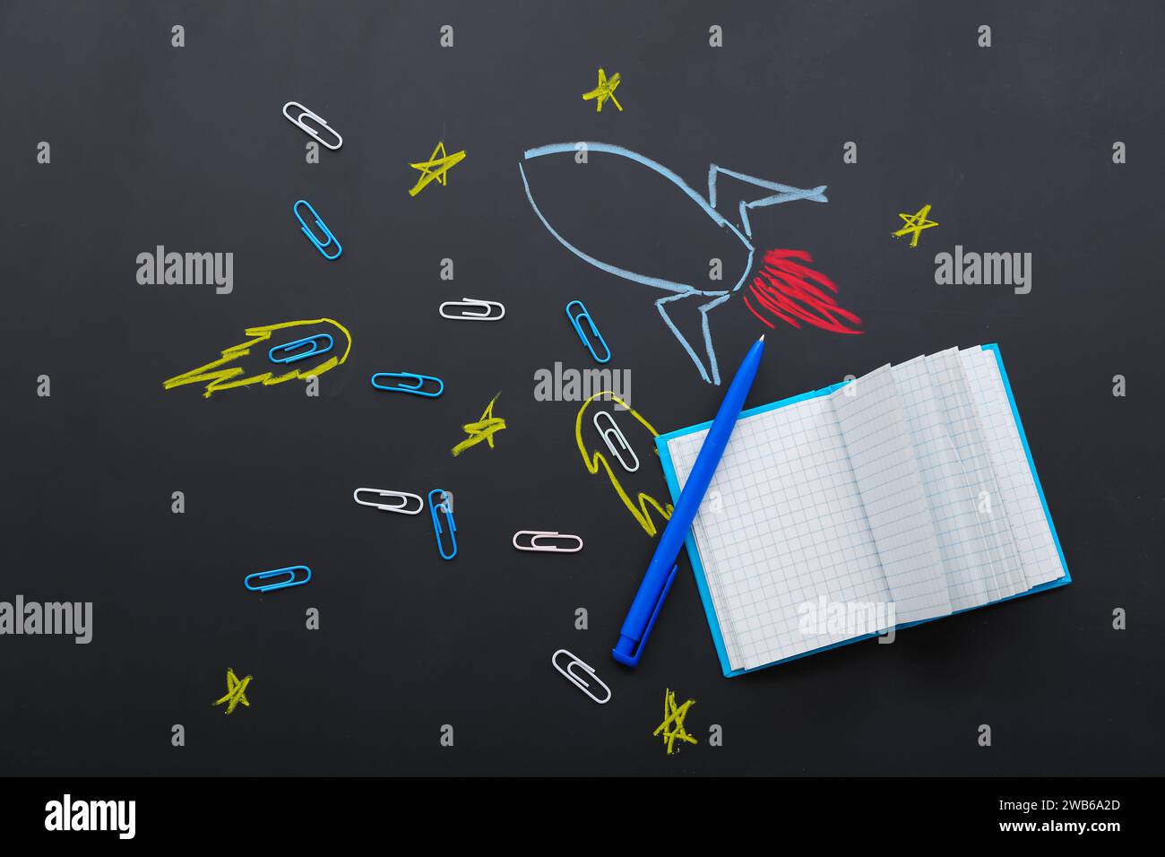 Creative composition with drawn rocket and different stationery on ...