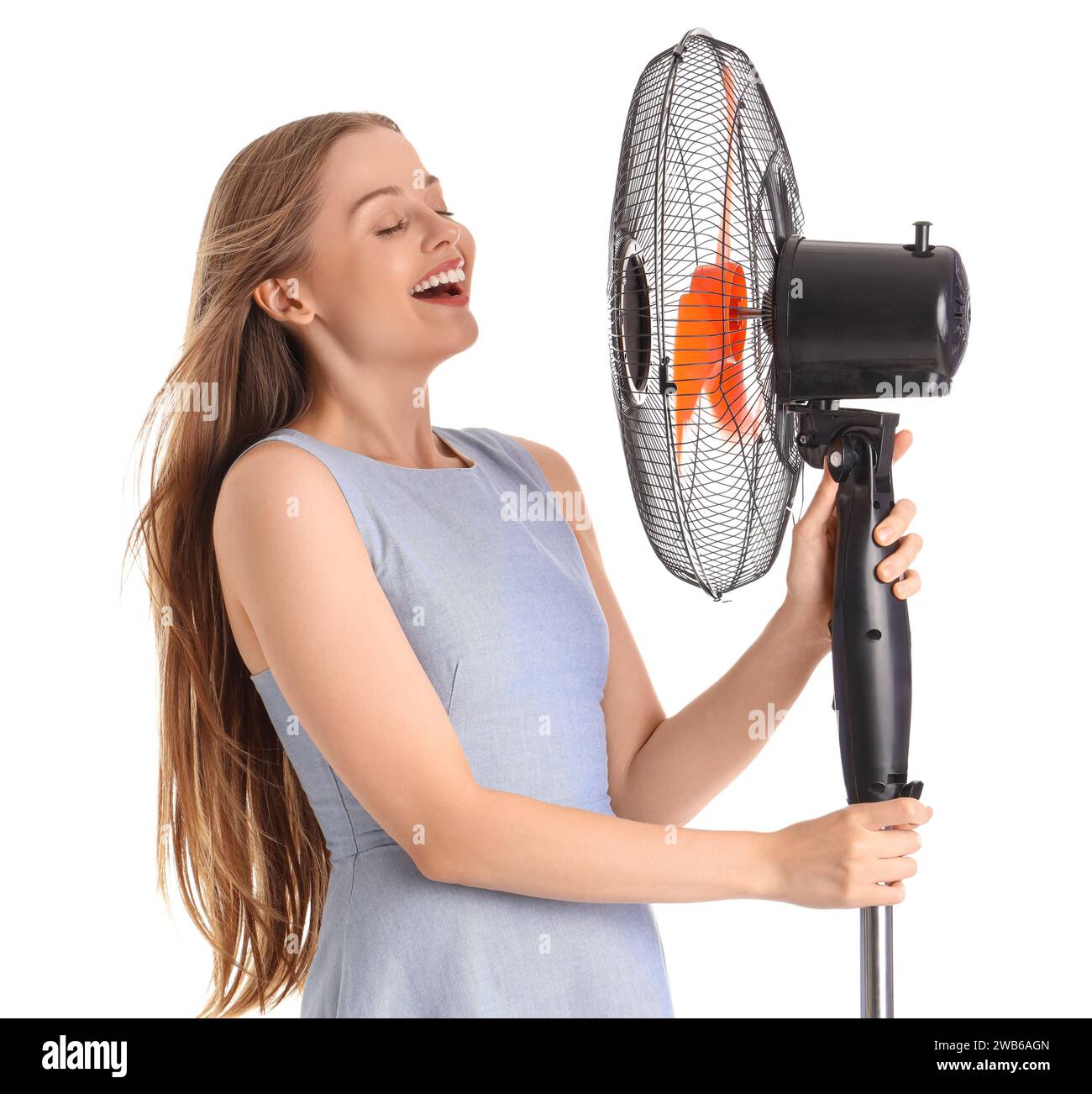 Young woman with electric fan on white background Stock Photo - Alamy