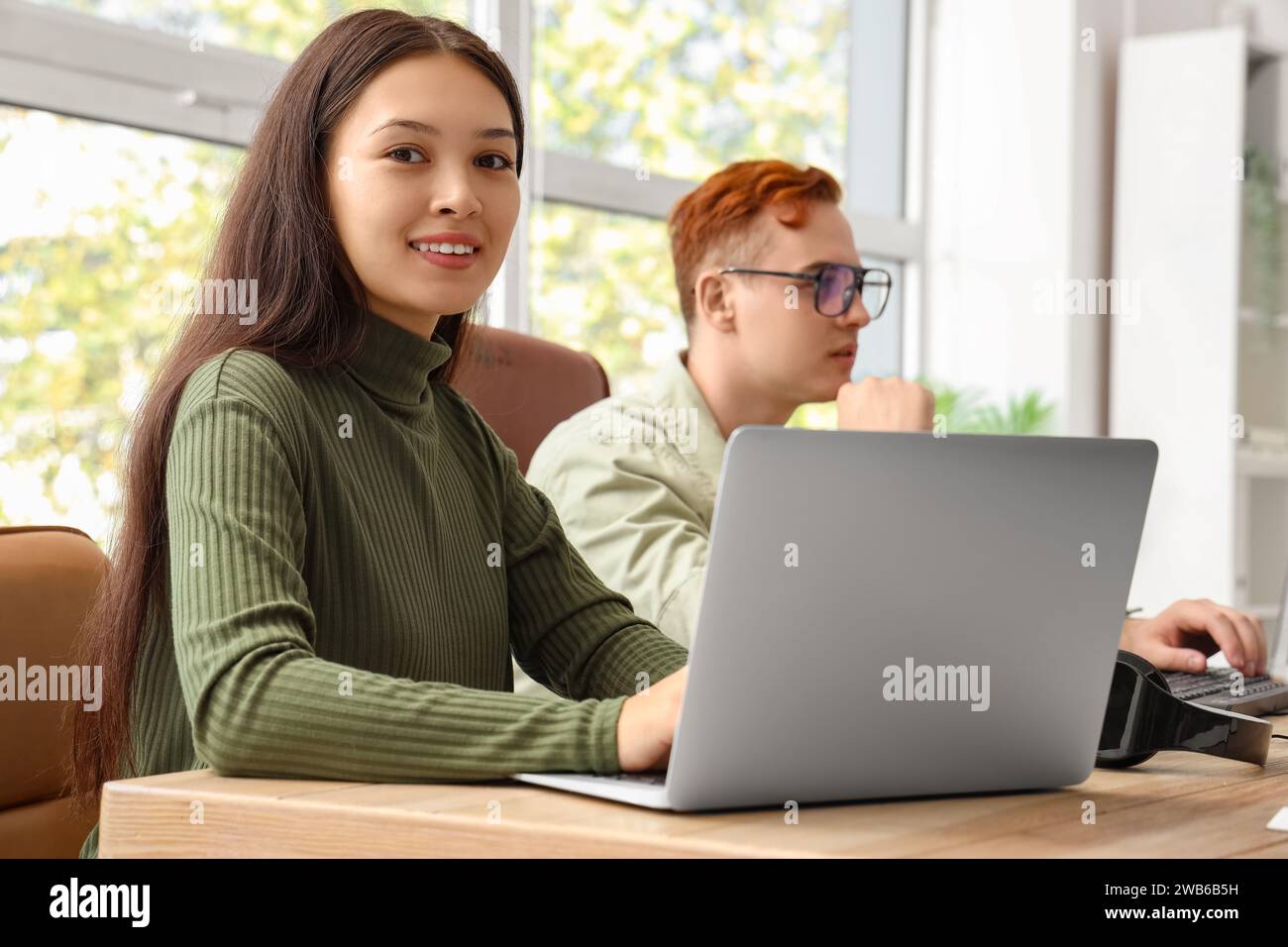 Female Asian programmer working in office Stock Photo - Alamy