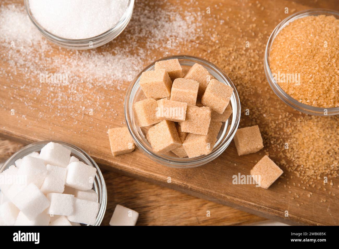 Bowls with different types of sugar on table Stock Photo - Alamy