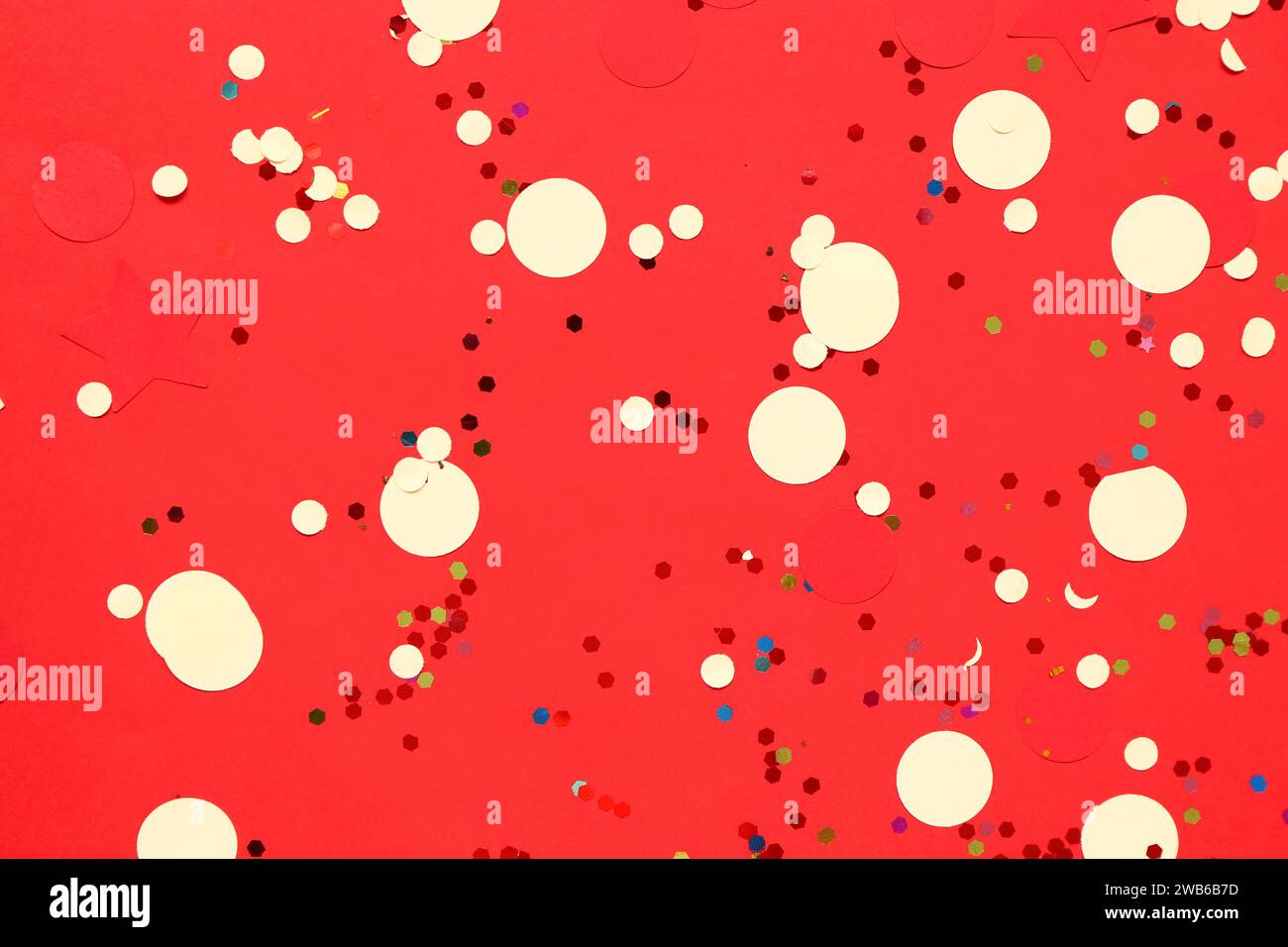 Colorful confetti on red background Stock Photo - Alamy