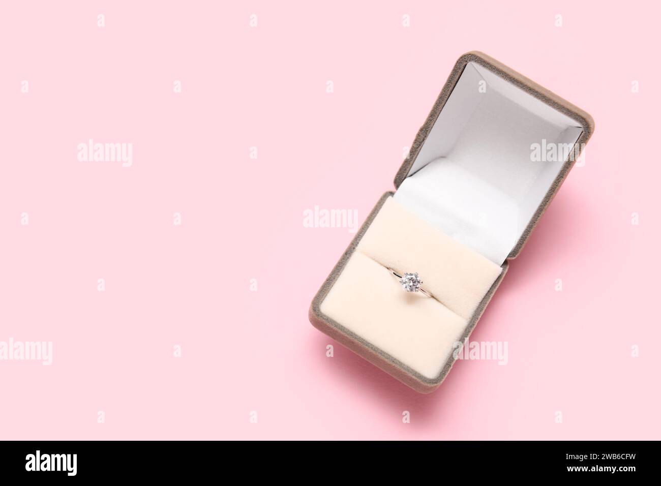 Box with beautiful engagement ring on pink background Stock Photo - Alamy