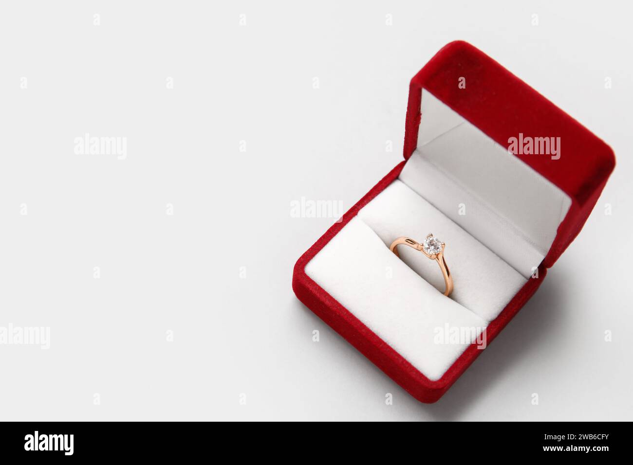 Box with beautiful engagement ring on white background Stock Photo - Alamy