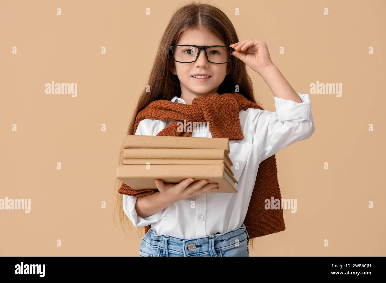 Cute little librarian with books on beige background. Opposite Day ...