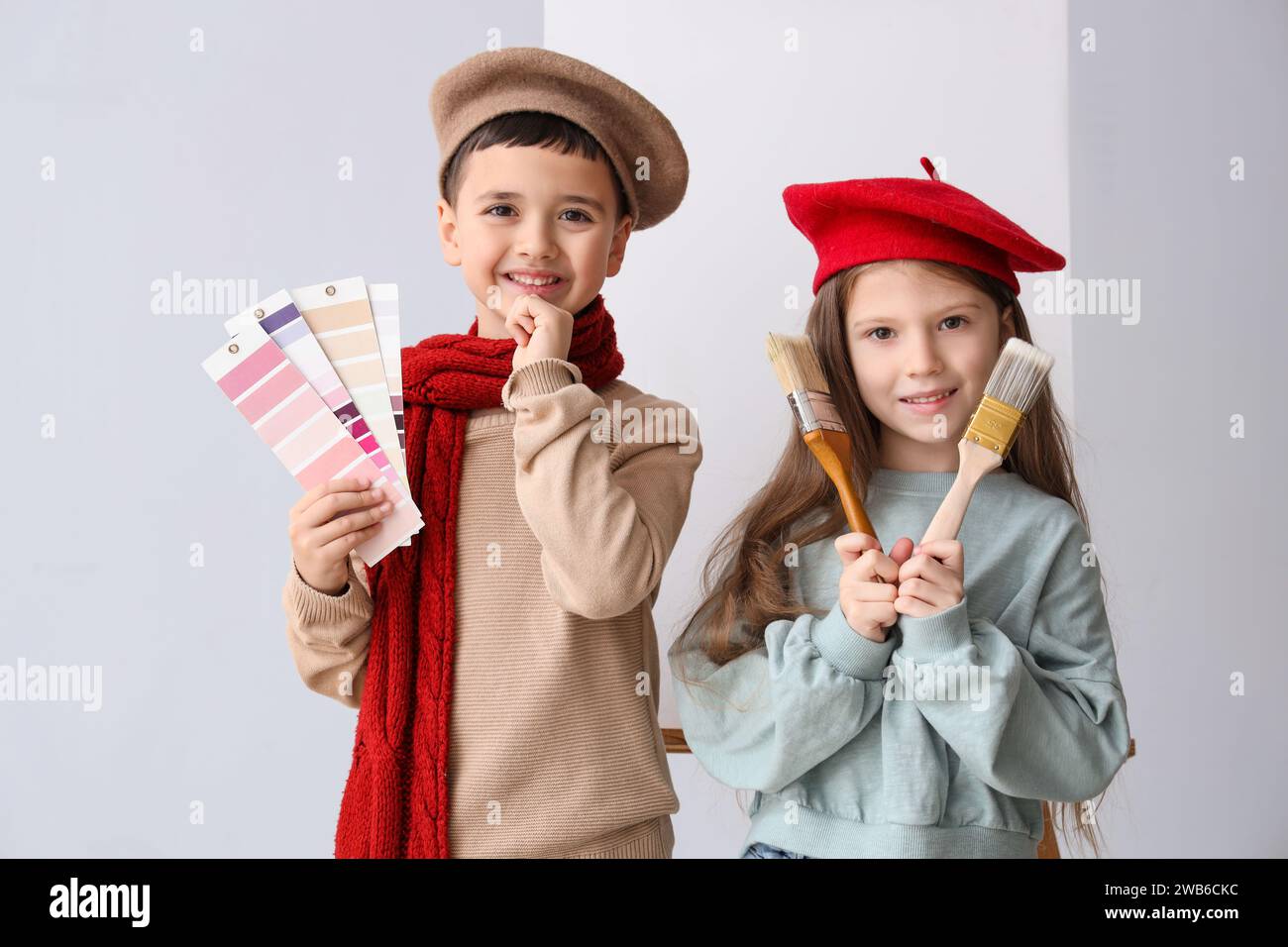 Cute little artists with paint color palettes and brushes on light ...