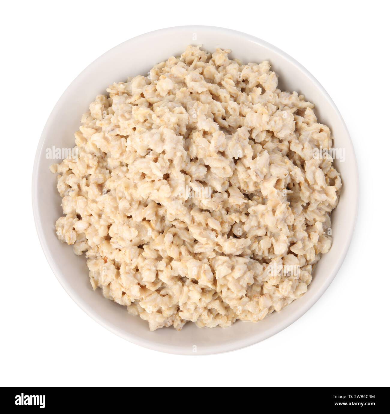 Tasty boiled oatmeal in bowl isolated on white, top view Stock Photo ...