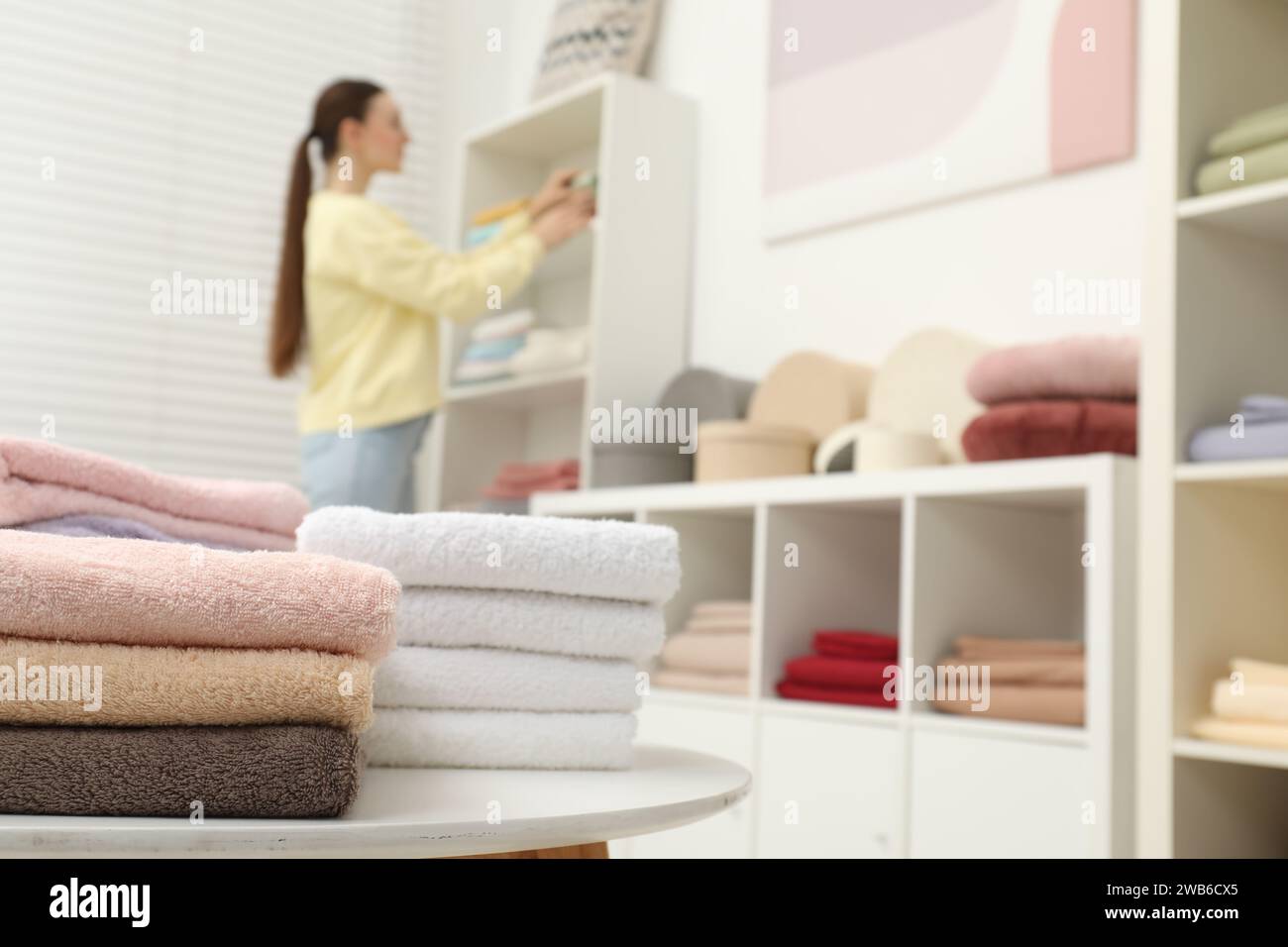 Stack of new towels on display in home textiles store, closeup. Space ...