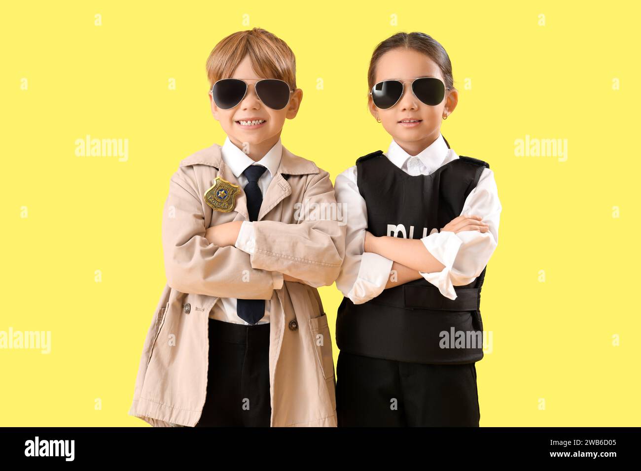 Cute little police officer and detective on yellow background. Opposite ...