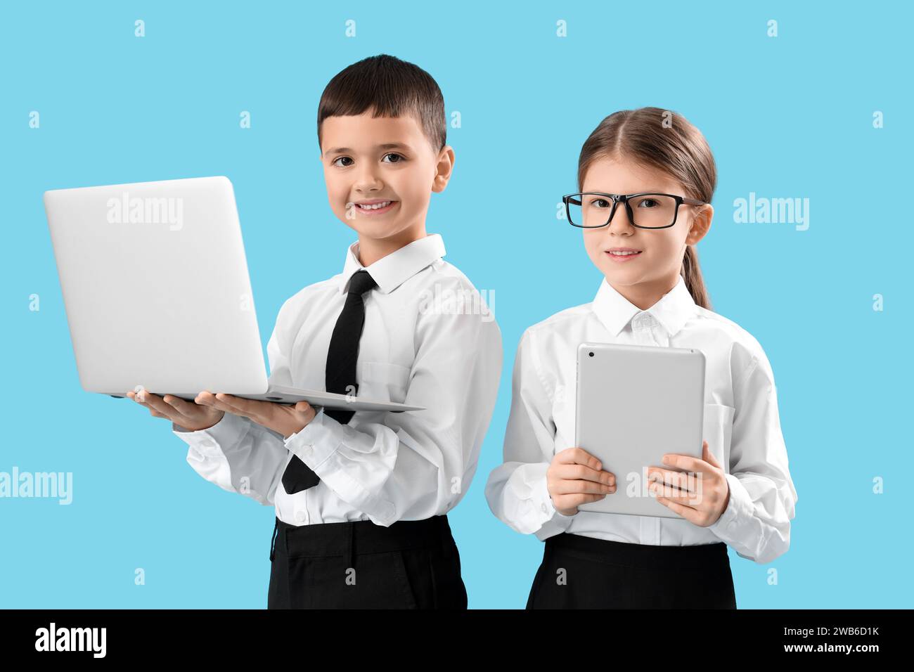 Little business colleagues with laptop and tablet computer on blue ...