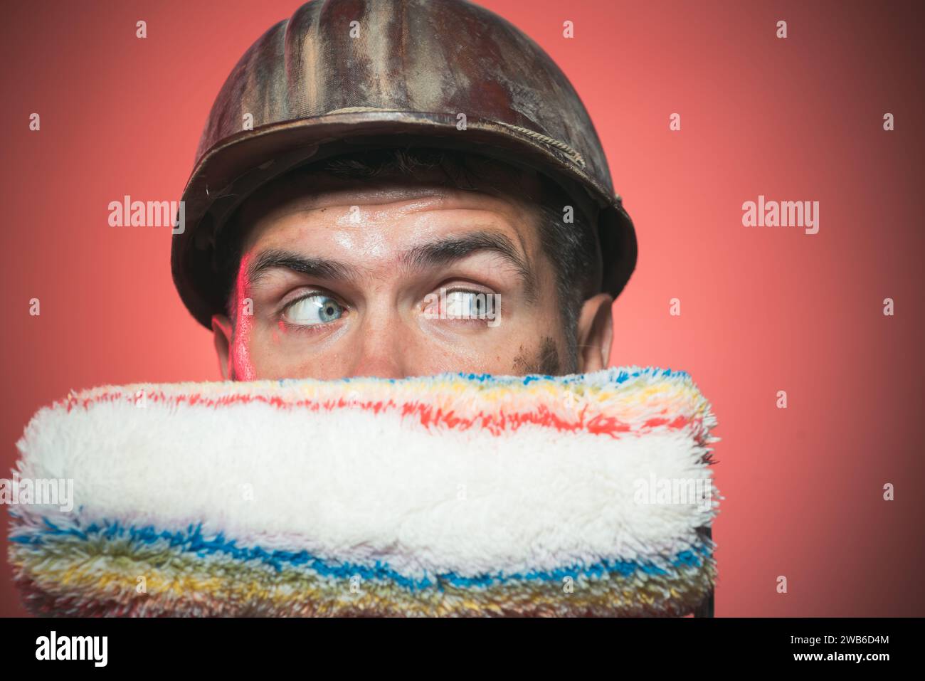 Professional painting. Closeup portrait of surprised male painter in ... Professional painting. Closeup portrait of surprised male painter in ...