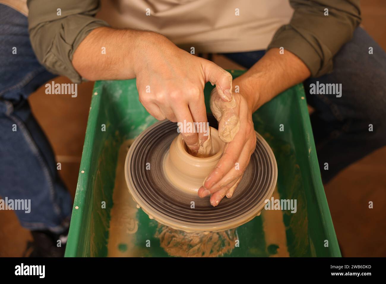 Clay crafting. Man making bowl on potter's wheel, closeup Stock Photo ...