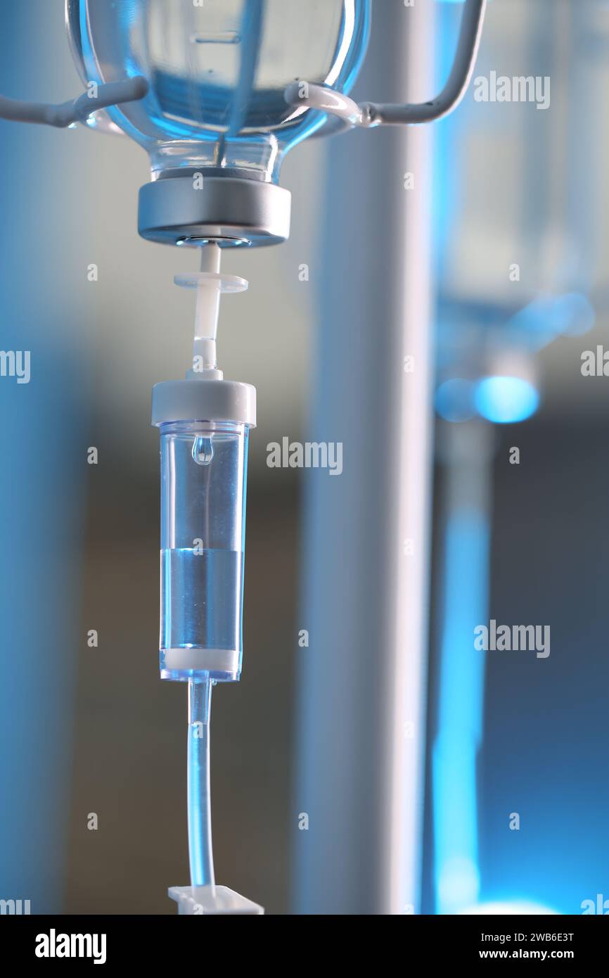 IV drip chamber against blurred light background Stock Photo - Alamy