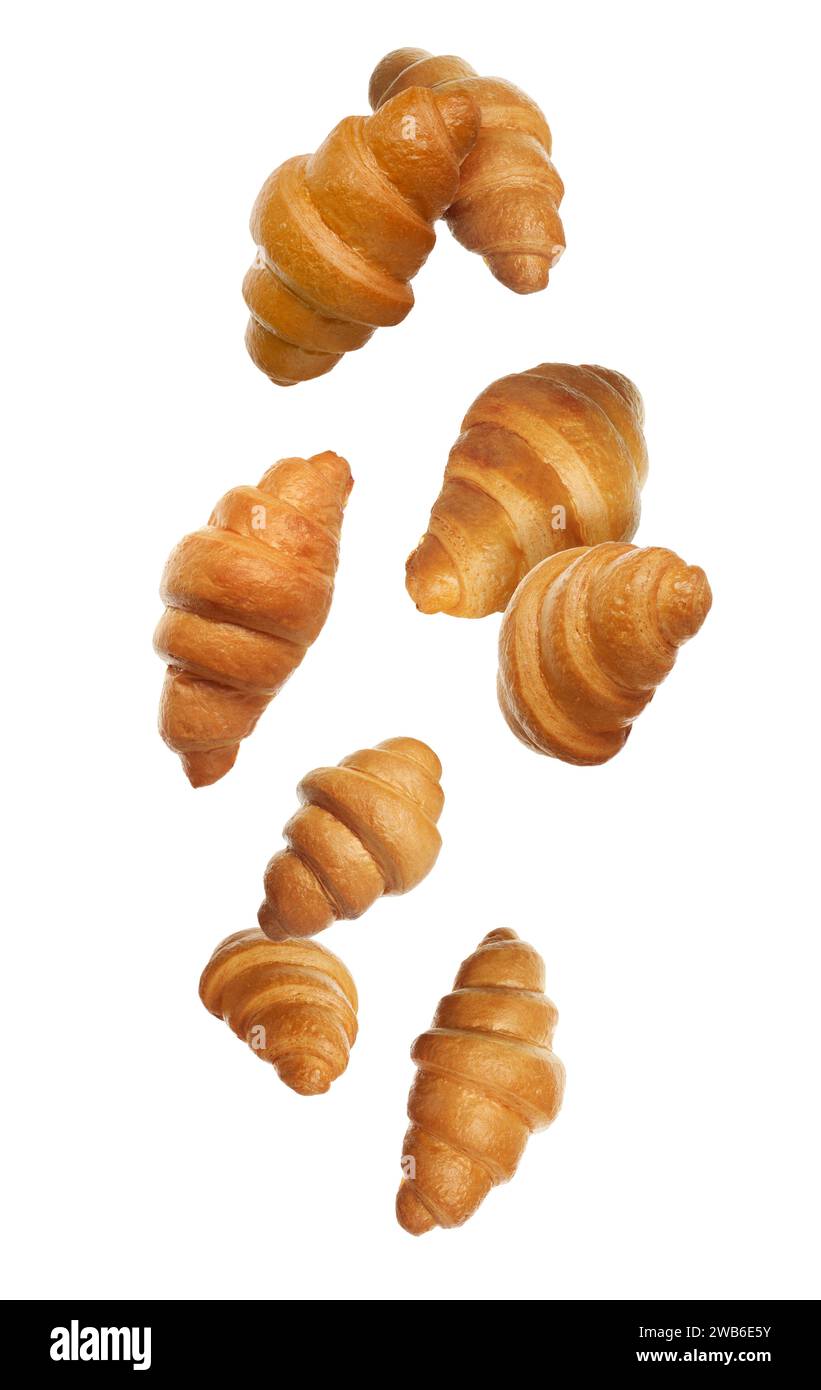 Crusty golden croissants falling on white background Stock Photo - Alamy