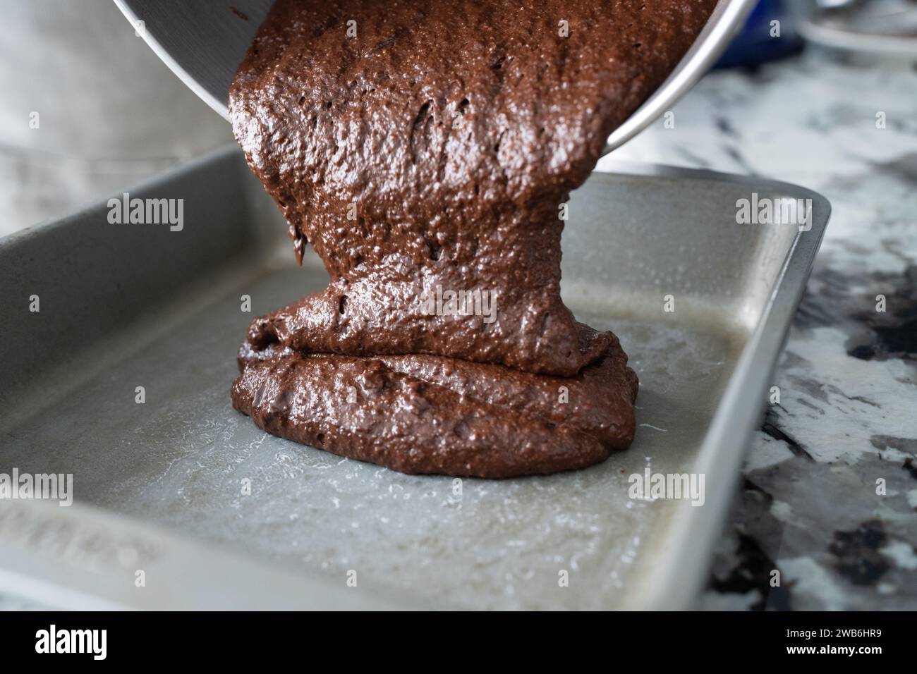 Pouring brownie mix into pan Stock Photo - Alamy
