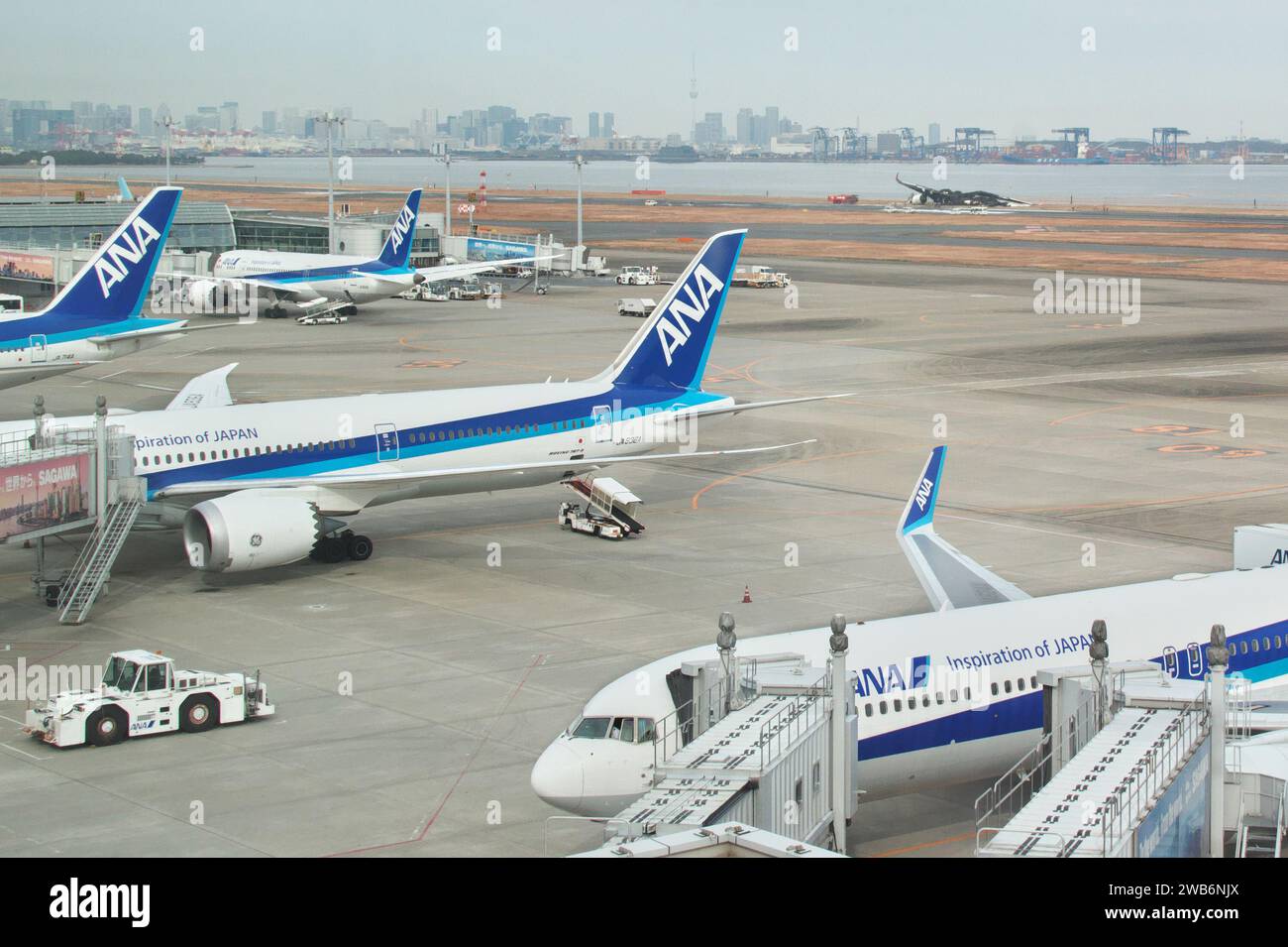Officials investigate a burnt Japan Airlines Airbus A350 after a ...