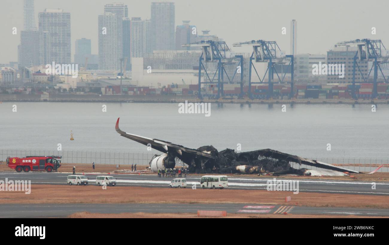 Officials investigate a burnt Japan Airlines Airbus A350 after a ...
