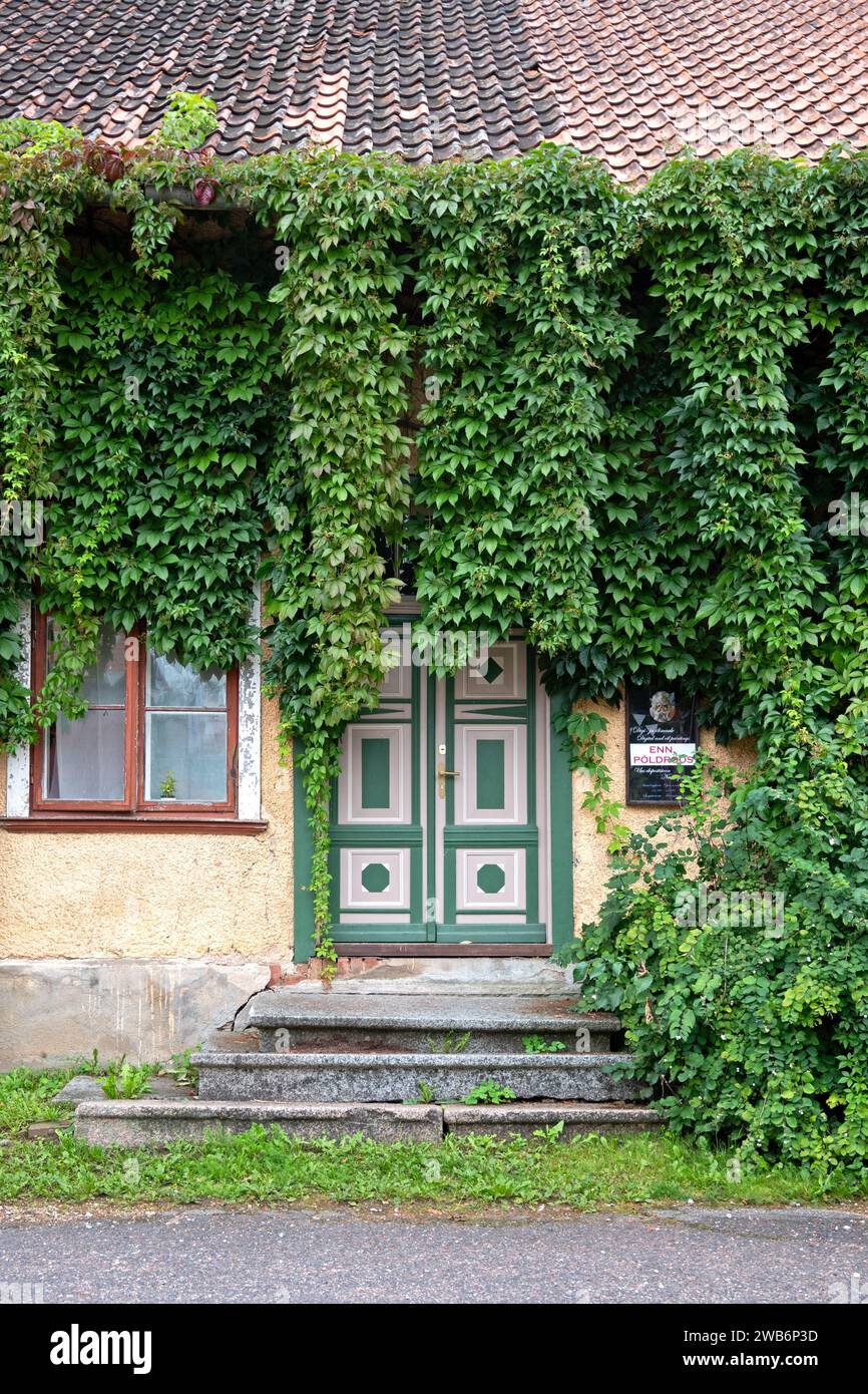 The doors of the Enn Põldroos Museum in Viljandi, Estonia, half-hidden ...