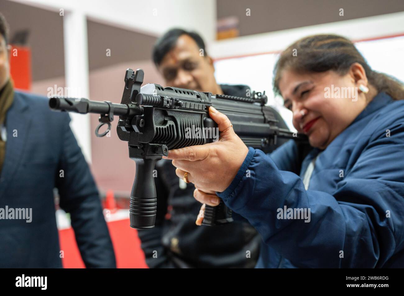 New Delhi, India. 08th Jan, 2024. A woman holds a made-in-India weapon ...