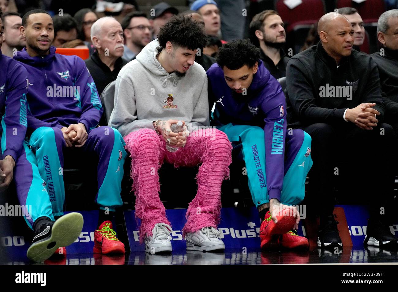 Charlotte Hornets' LaMelo Ball, center, and James Bouknight look over ...