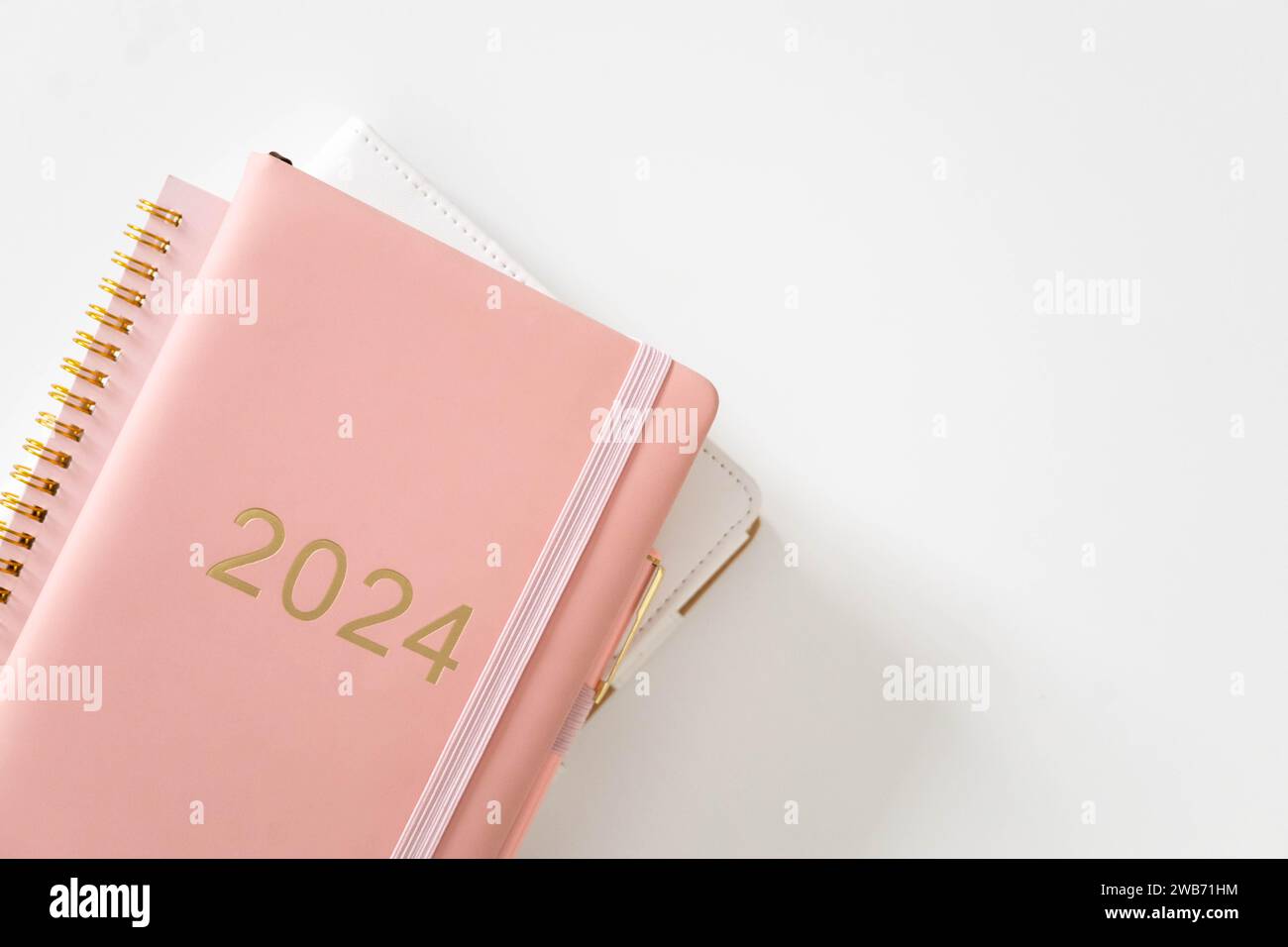 Pink coral colored diary for the year 2024 and many other diaries, pen ...