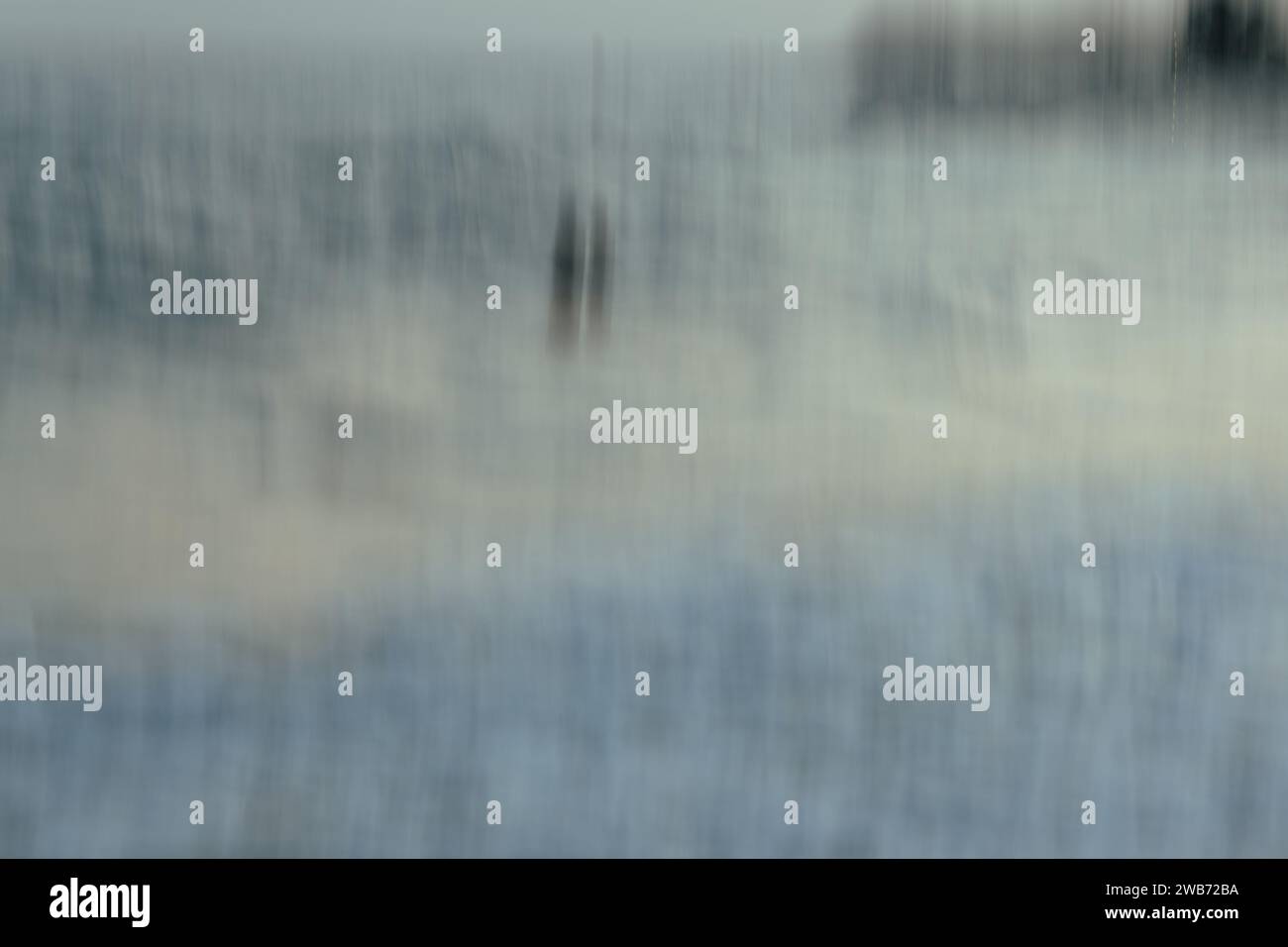 Vertical blur from intentional camera movement of a beach scene with ...