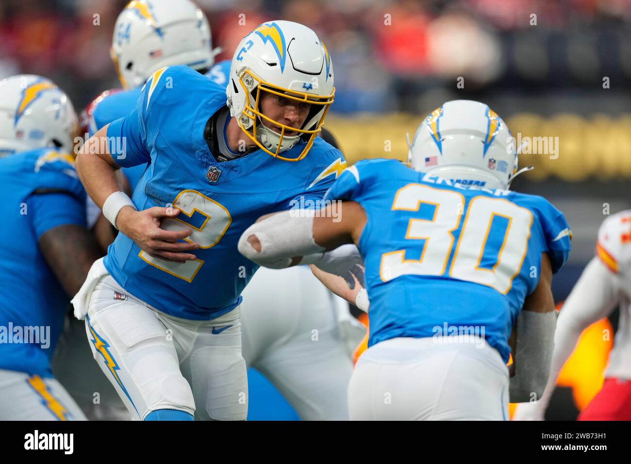 Los Angeles Chargers quarterback Easton Stick (2) hands off to running ...