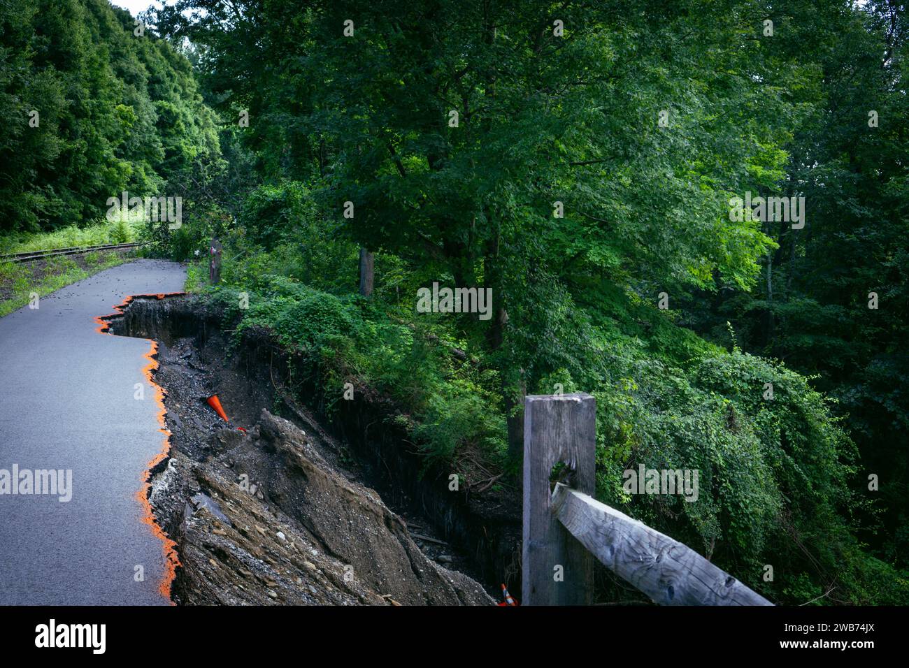damaged and collapsed part of the concrete road due to flooding and ...