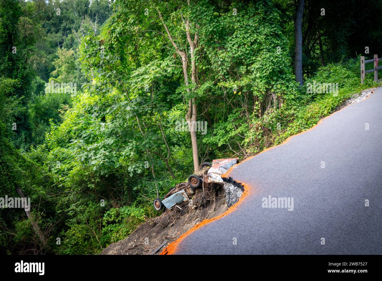 damaged and collapsed part of the concrete road due to flooding and ...
