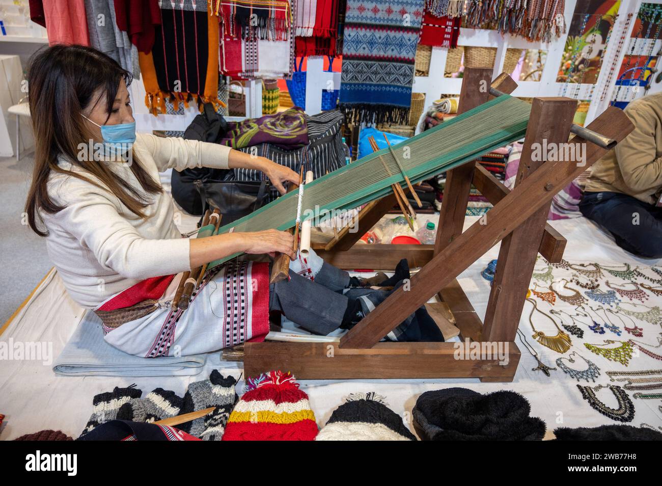 New Delhi, India. 08th Jan, 2024. An Indian artisan showcases her work ...